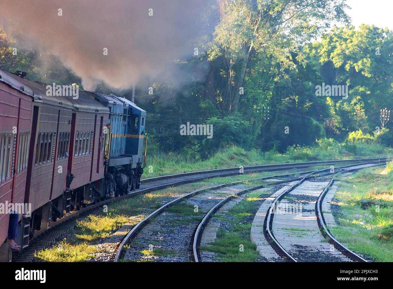 Train arrives at platform with passengers in Srilanka. Simple commuter ...