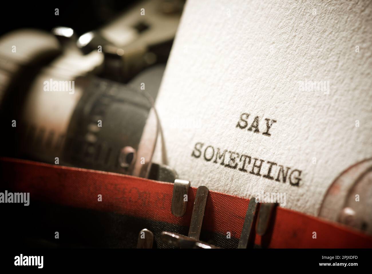 Say something text written with a typewriter Stock Photo - Alamy