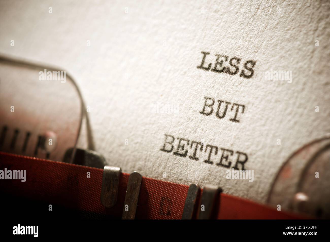 Less but better text written with a typewriter Stock Photo - Alamy