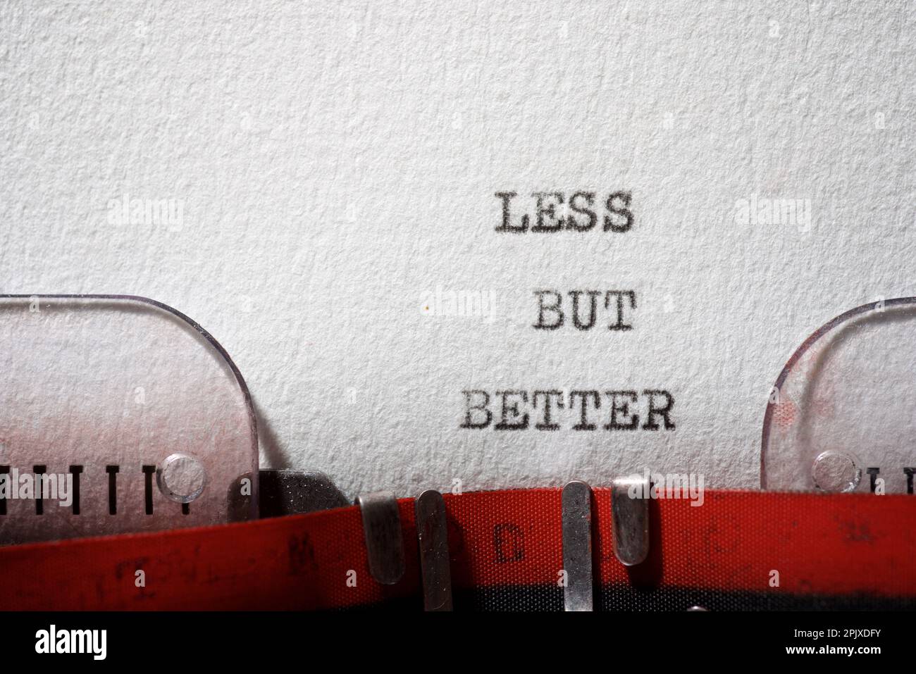 Less but better text written with a typewriter Stock Photo - Alamy