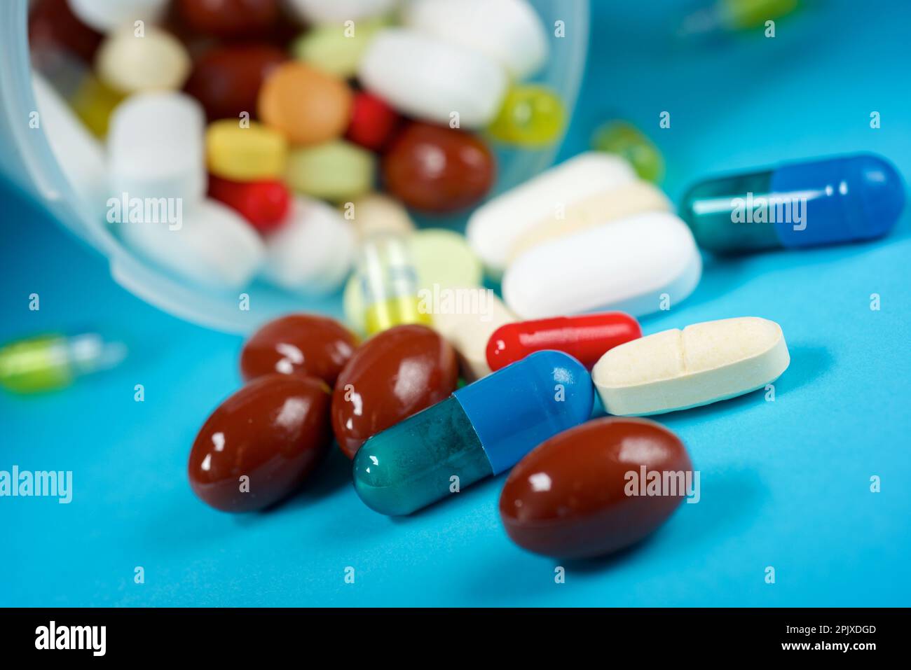 Close-up of medication tablets coming out of a plastic canister Stock ...
