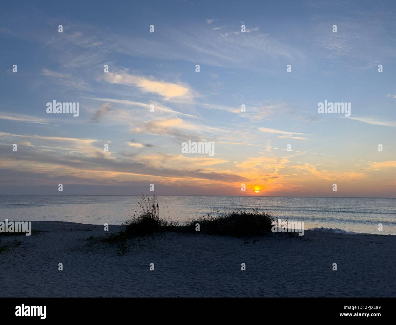 A view of a Sunset on the beach at Siesta Key, Florida with a beautiful ...