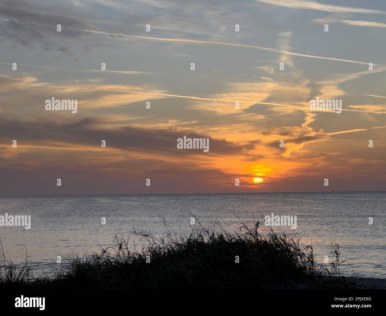 A view of a Sunset on the beach at Siesta Key, Florida with a beautiful ...