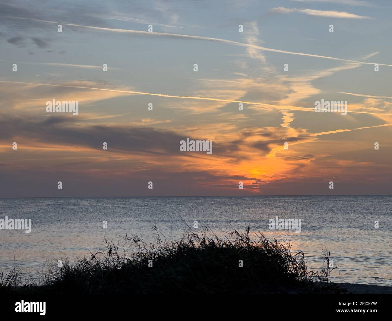 A view of a Sunset on the beach at Siesta Key, Florida with a beautiful ...