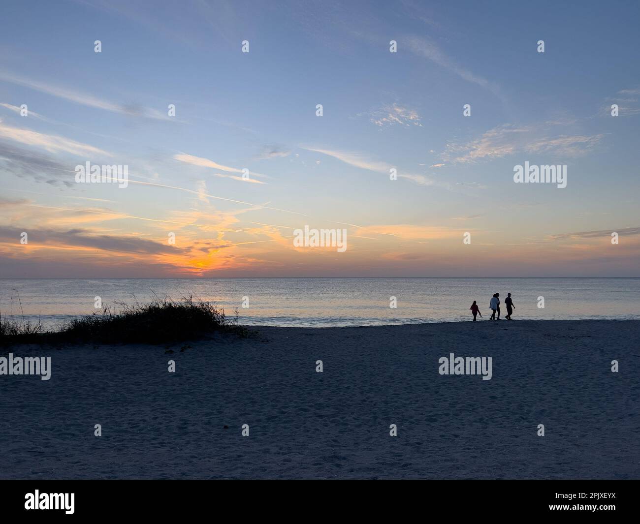 A view of a Sunset on the beach at Siesta Key, Florida with a beautiful ...