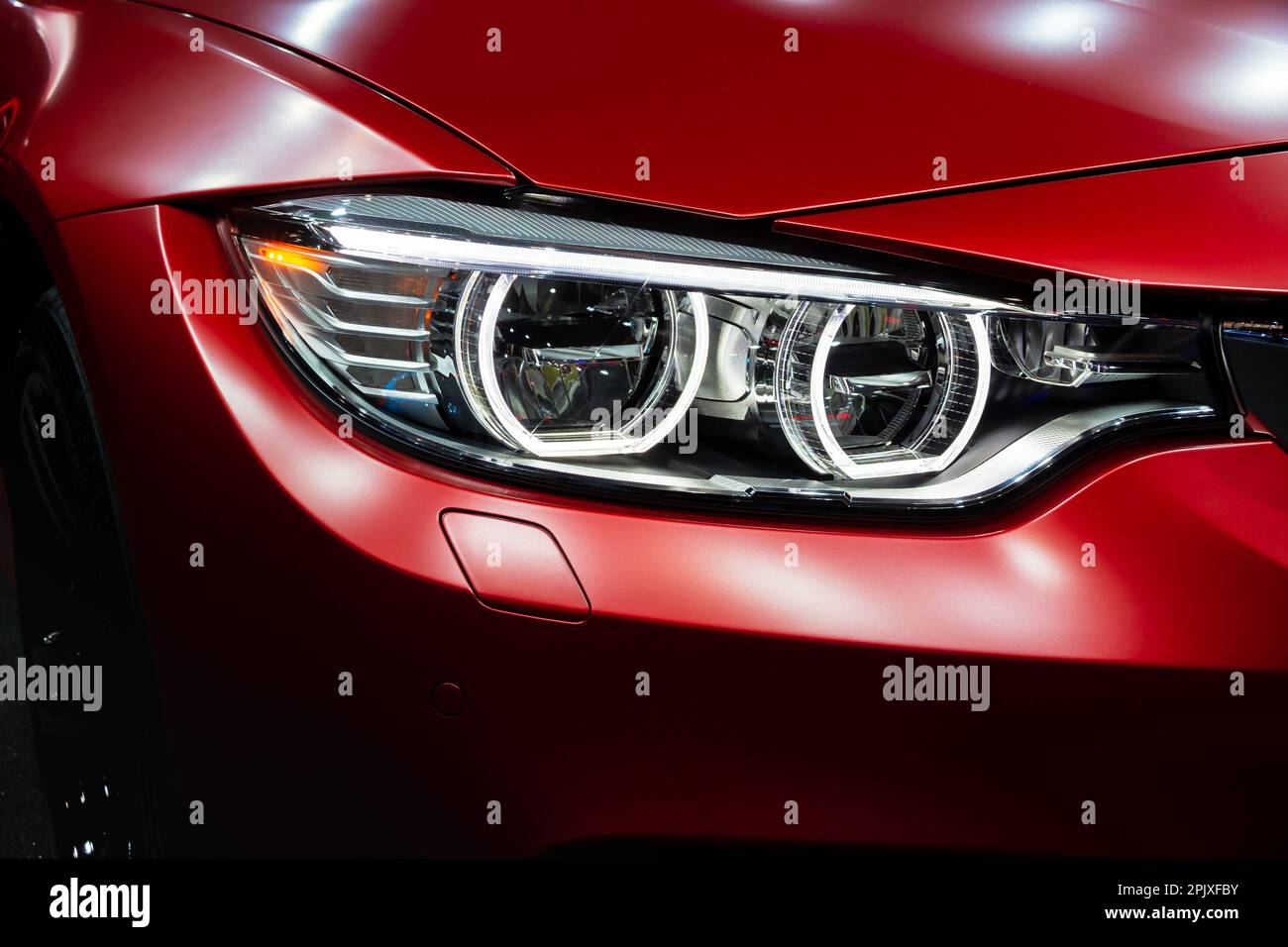 Headlight close up of a BMW M4 car showcased at the IAA Motor Show ...