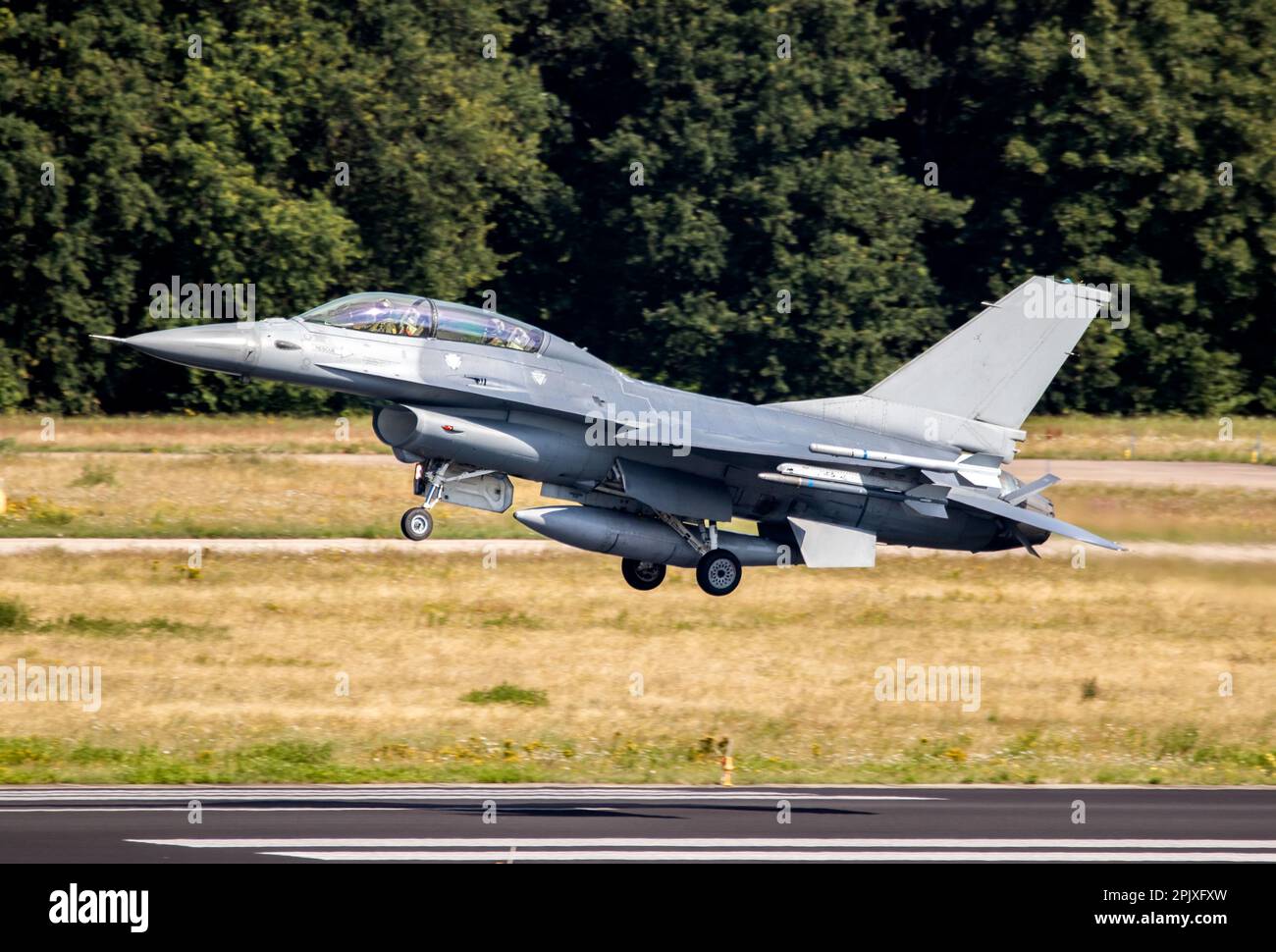 Air force fighter jet plane taking off from an airbase with full speed ...