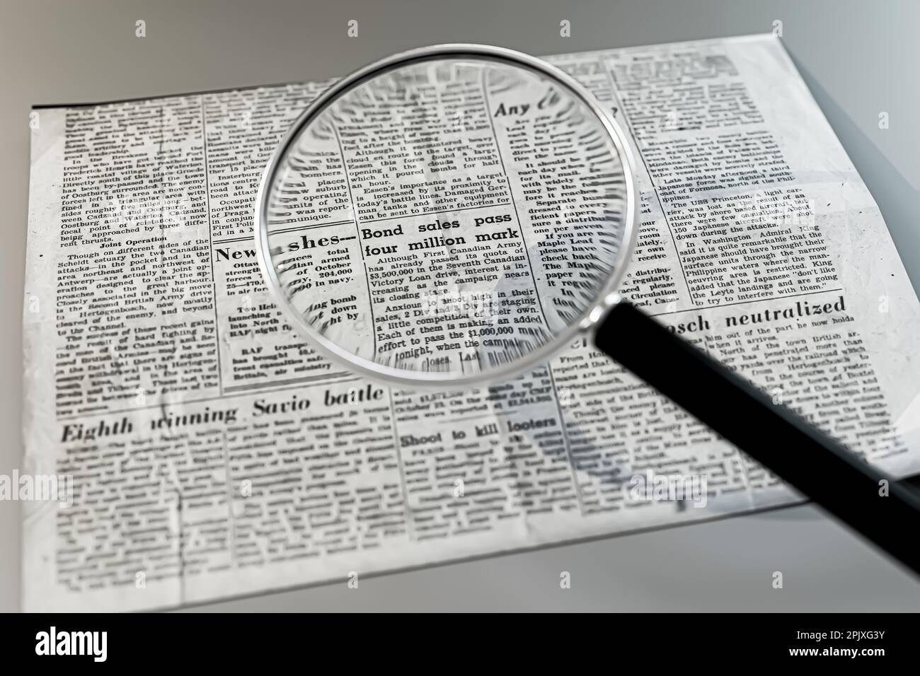 magnifier tool on a newspaper 3d illustration Stock Photo - Alamy