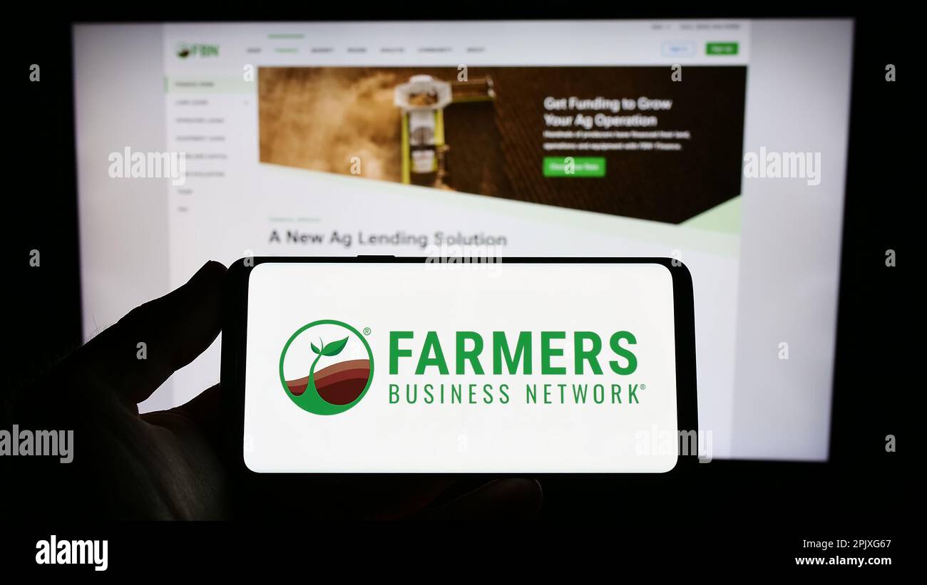 Person holding smartphone with logo of agriculture platform Farmers ...