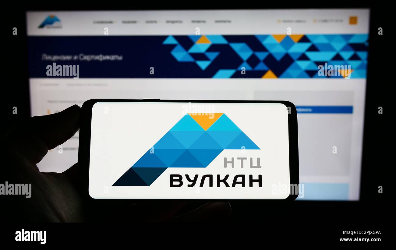 Person holding mobile phone with logo of Russian information technology ...