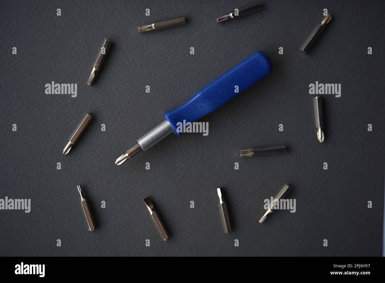 Replaceable nozzles for a screwdriver. Blue screwdriver with ...