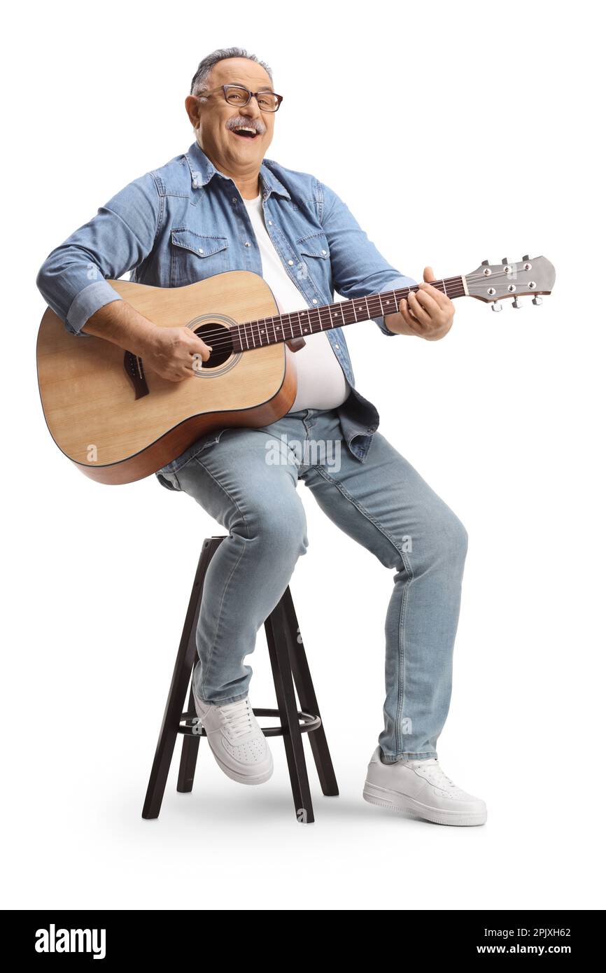 Full length portrait of a mature cheerful man sitting and playing an ...