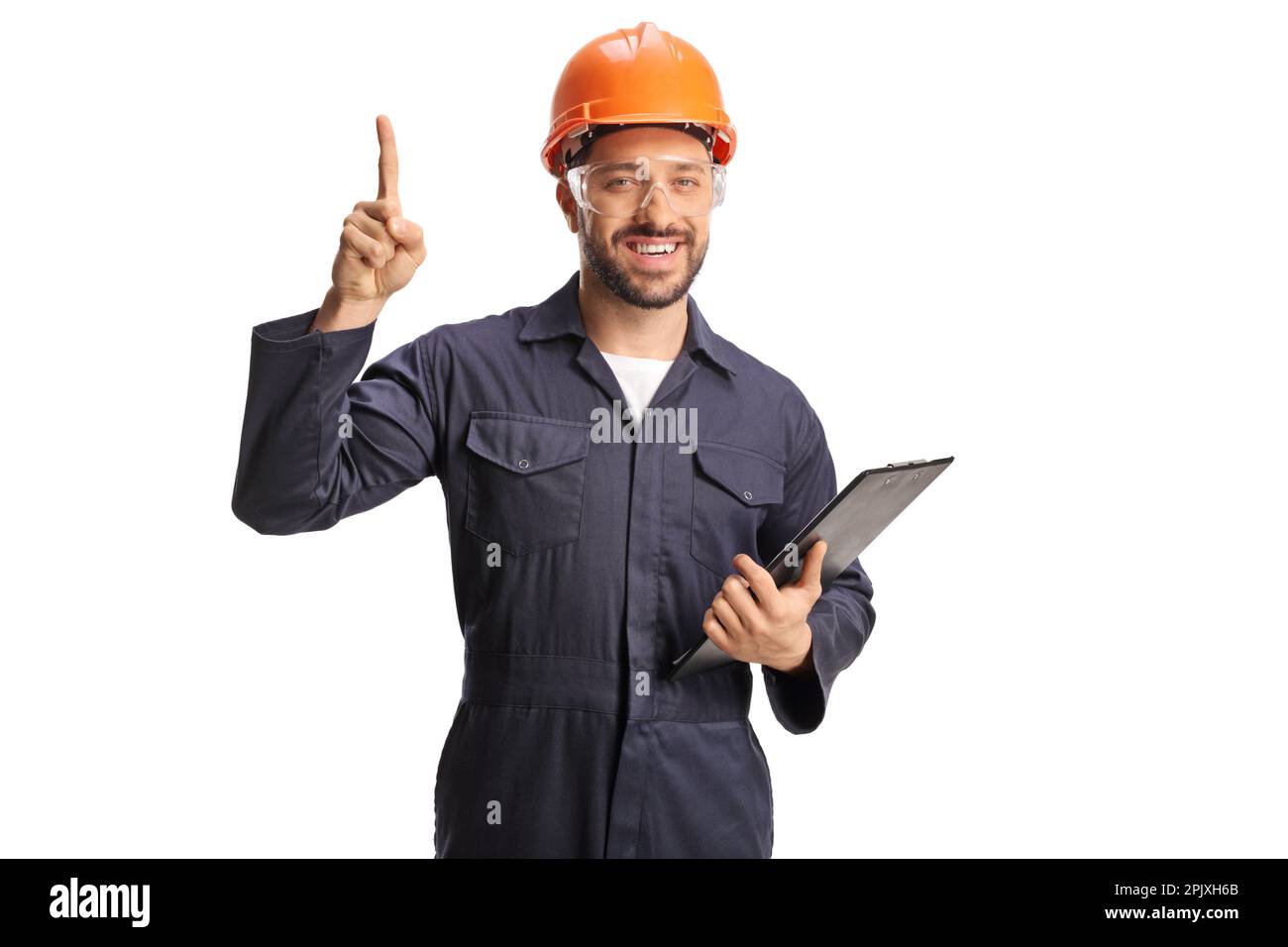 Factory worker wearing a protective helmet and goggles and pointing up ...