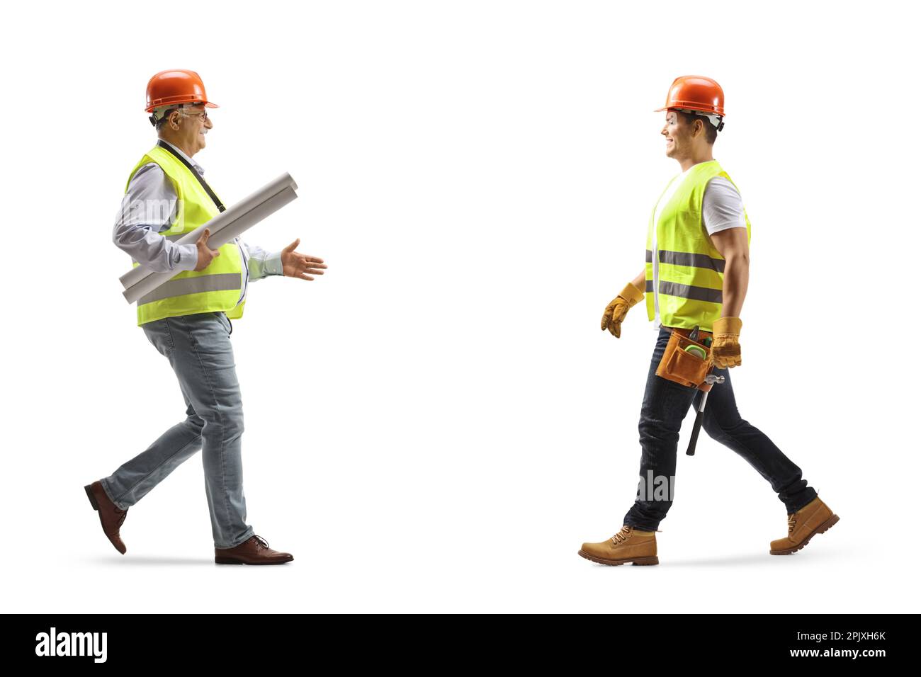 Full length profile shot of an engineer carrying blueprints and ...