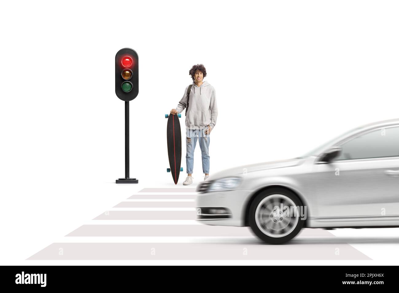 Guy with a longboard waiting waiting the green light on a traffic light ...