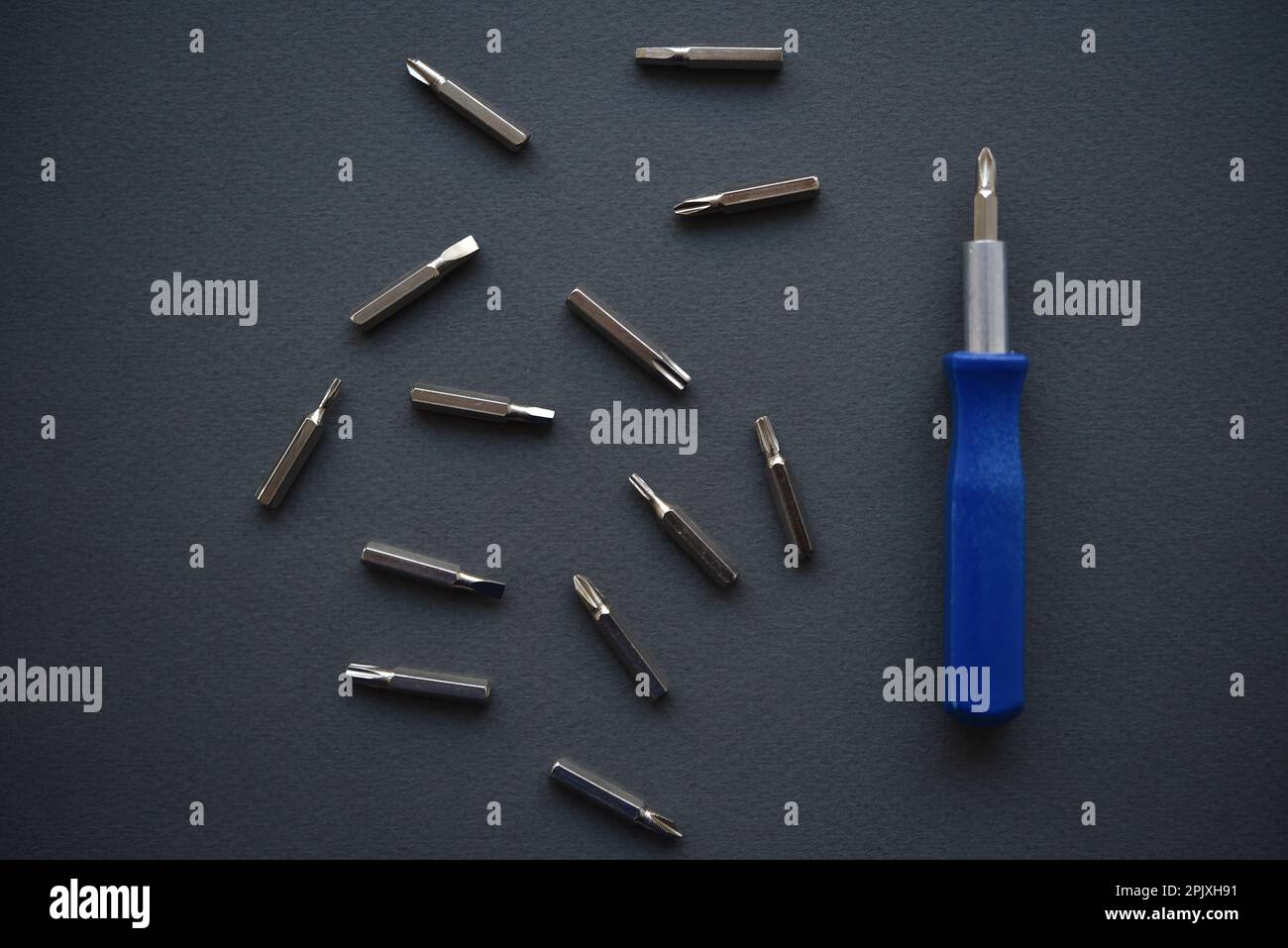 Replaceable nozzles for a screwdriver. Blue screwdriver with ...