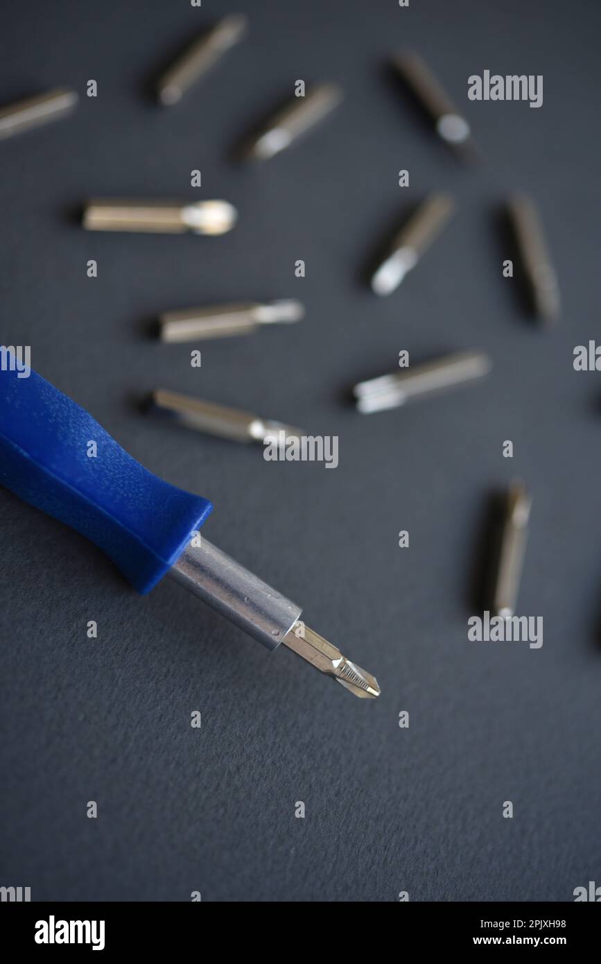 Replaceable nozzles for a screwdriver. Blue screwdriver with ...