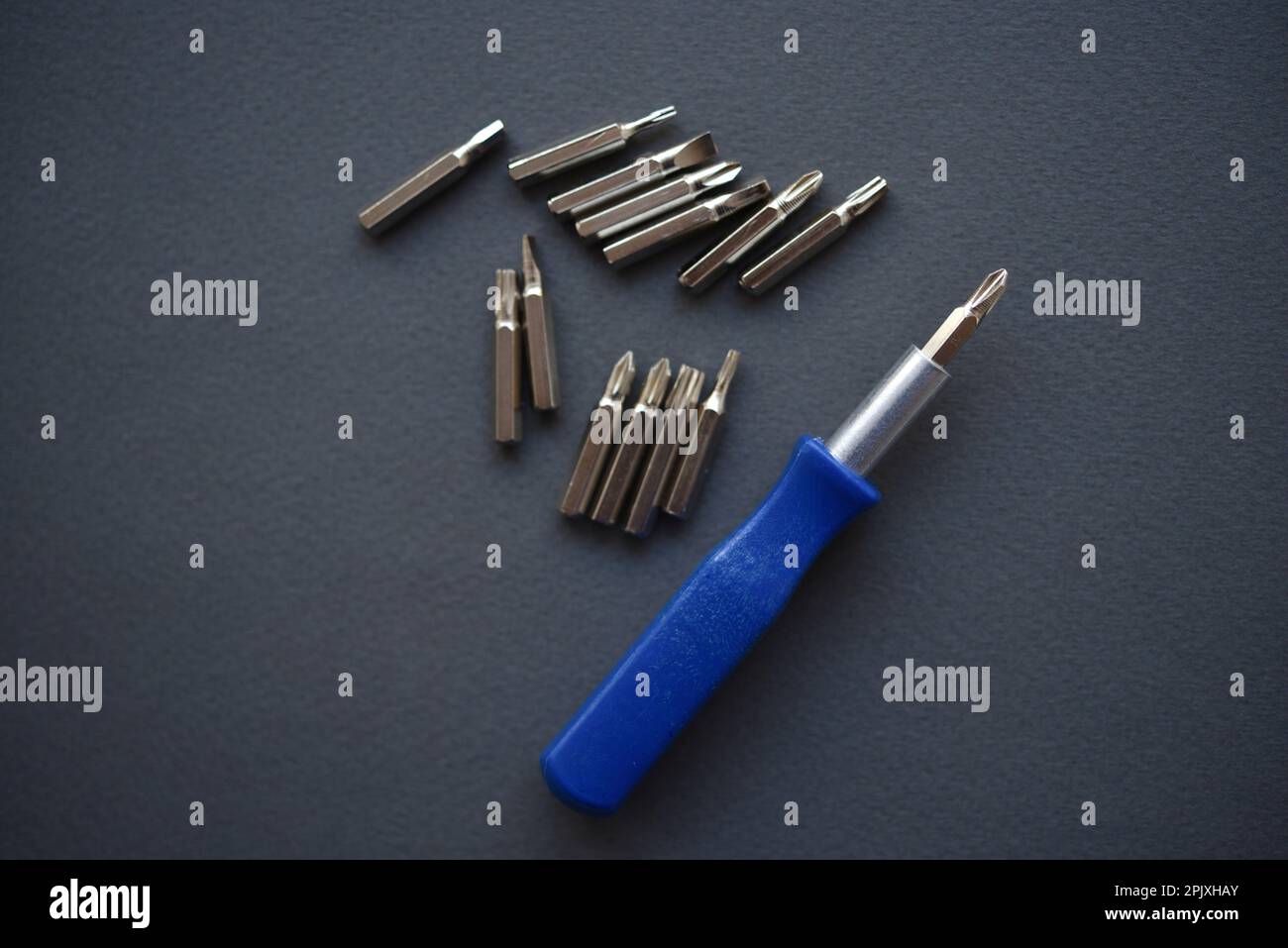 Replaceable nozzles for a screwdriver. Blue screwdriver with ...