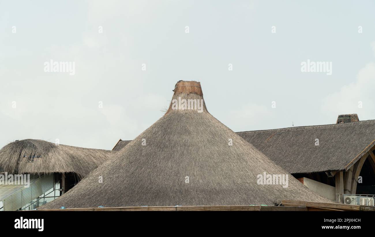 Thatched roof funnel against the sky Stock Photo - Alamy