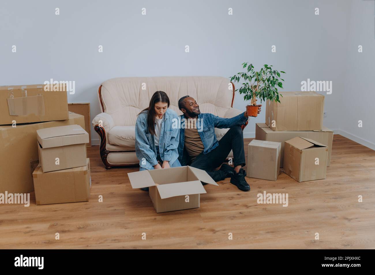 Couple Moving In House Interracial Couple Sitting Near Cardboard Boxes