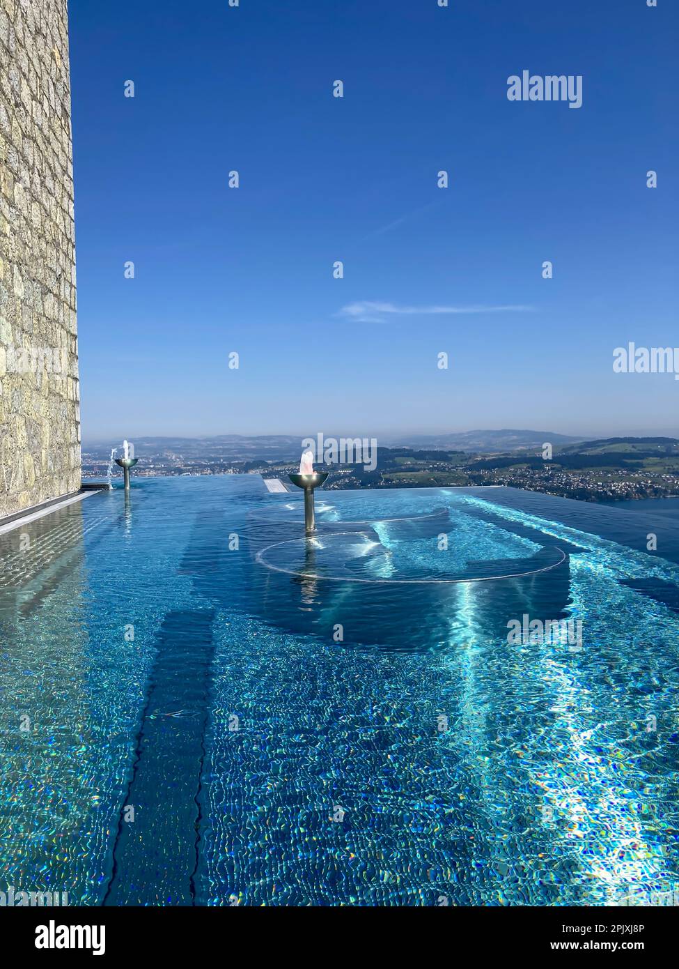Infinity Swimming Pool with Mountain and Lake Lucerne View in a Sunny ...