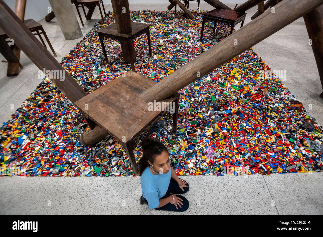 London, UK. 4 April 2023. A staff member next to 'Untitled (Lego ...