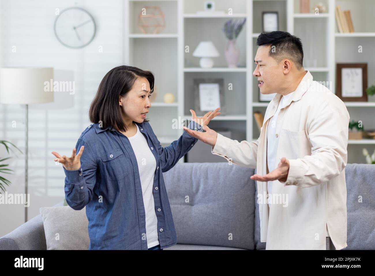 Family quarrel, asian couple man and woman yelling at each other, family conflict, asians at ...