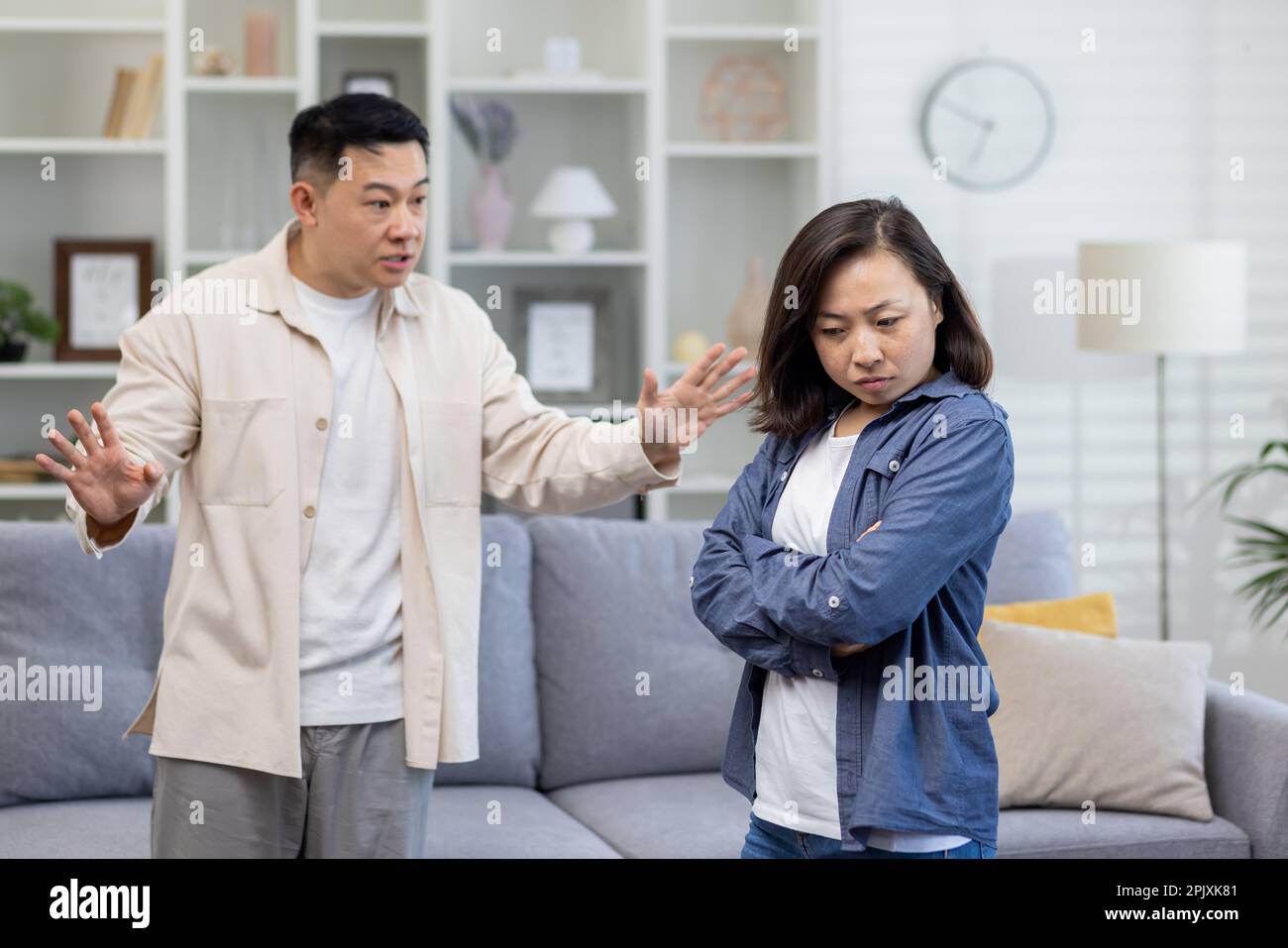 Family quarrel, asian couple man and woman yelling at each other ...