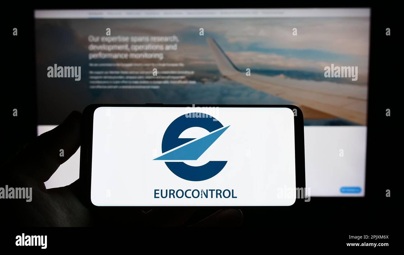 Person holding smartphone with logo of air traffic management ...