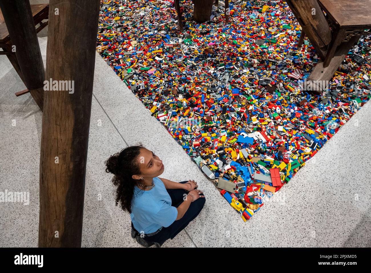 London, UK. 4 April 2023. A staff member next to 'Untitled (Lego ...