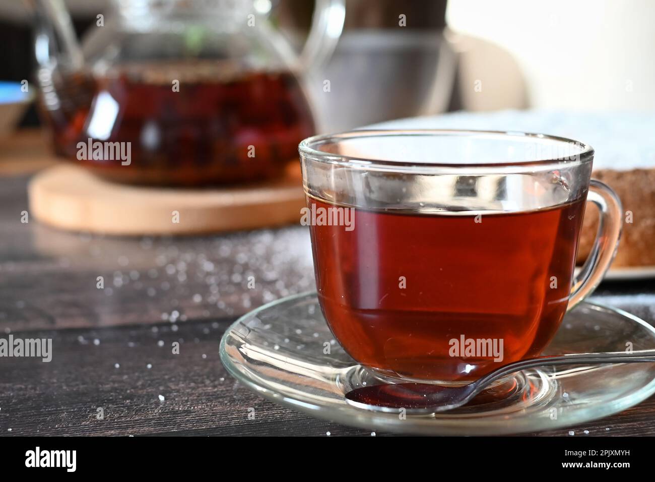 A Cup of freshly brewed black tea,escaping steam,warm soft light ...