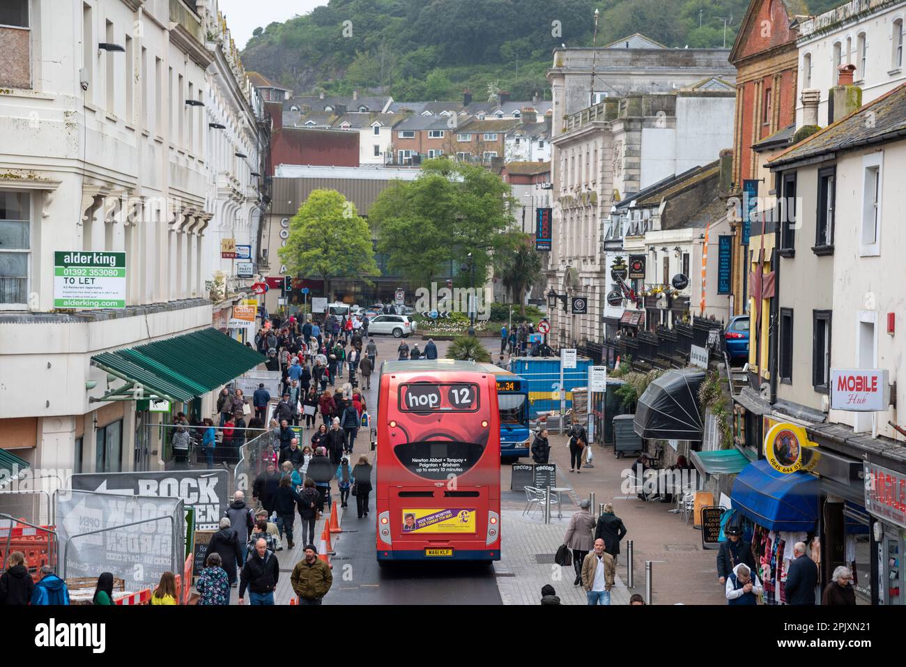 TORQUE,DEVON,ENGLAND-MAY 02,2015-Red bus in a fleet street in Torque ...