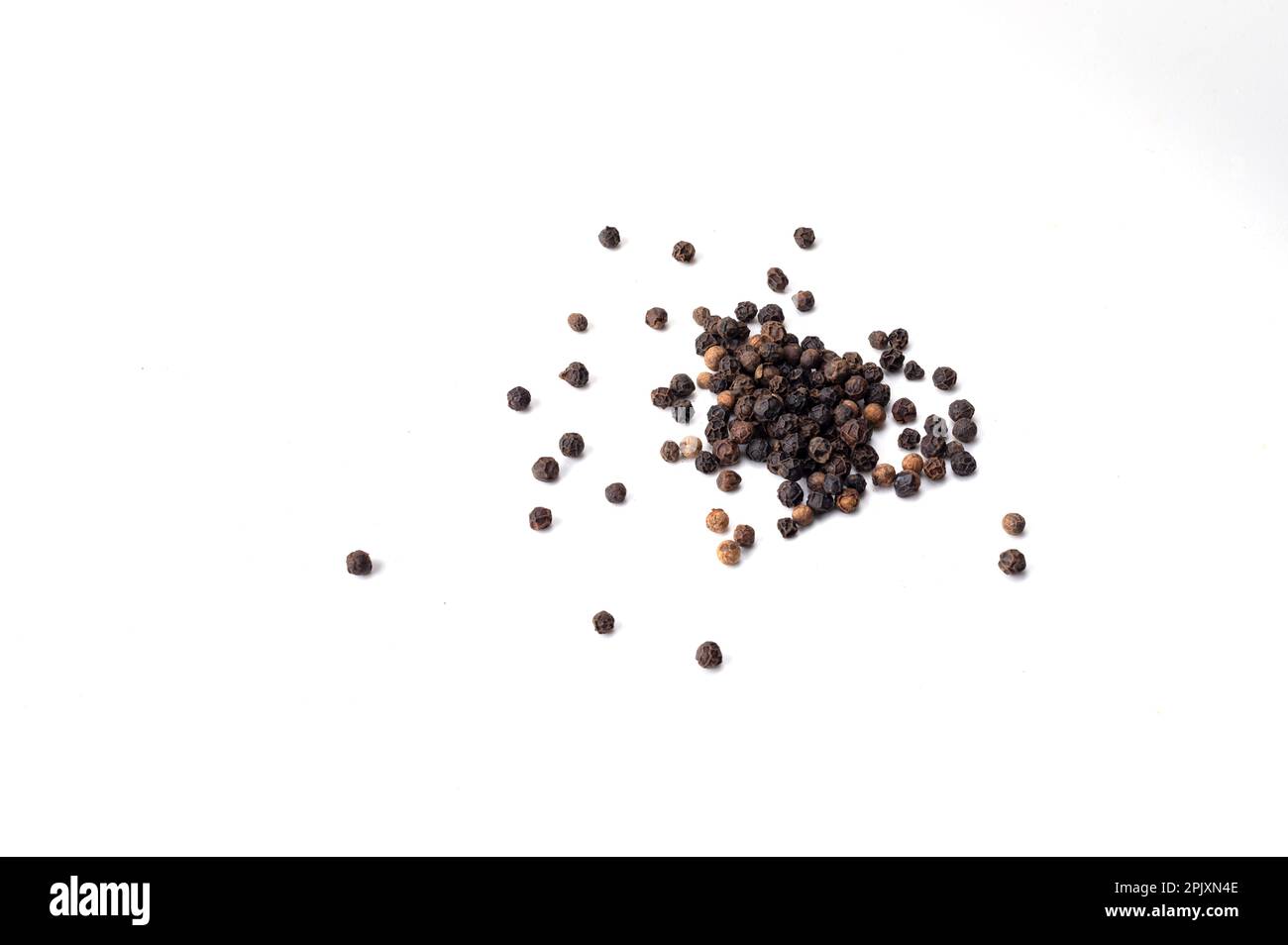 Black pepper grains separated on white Stock Photo - Alamy