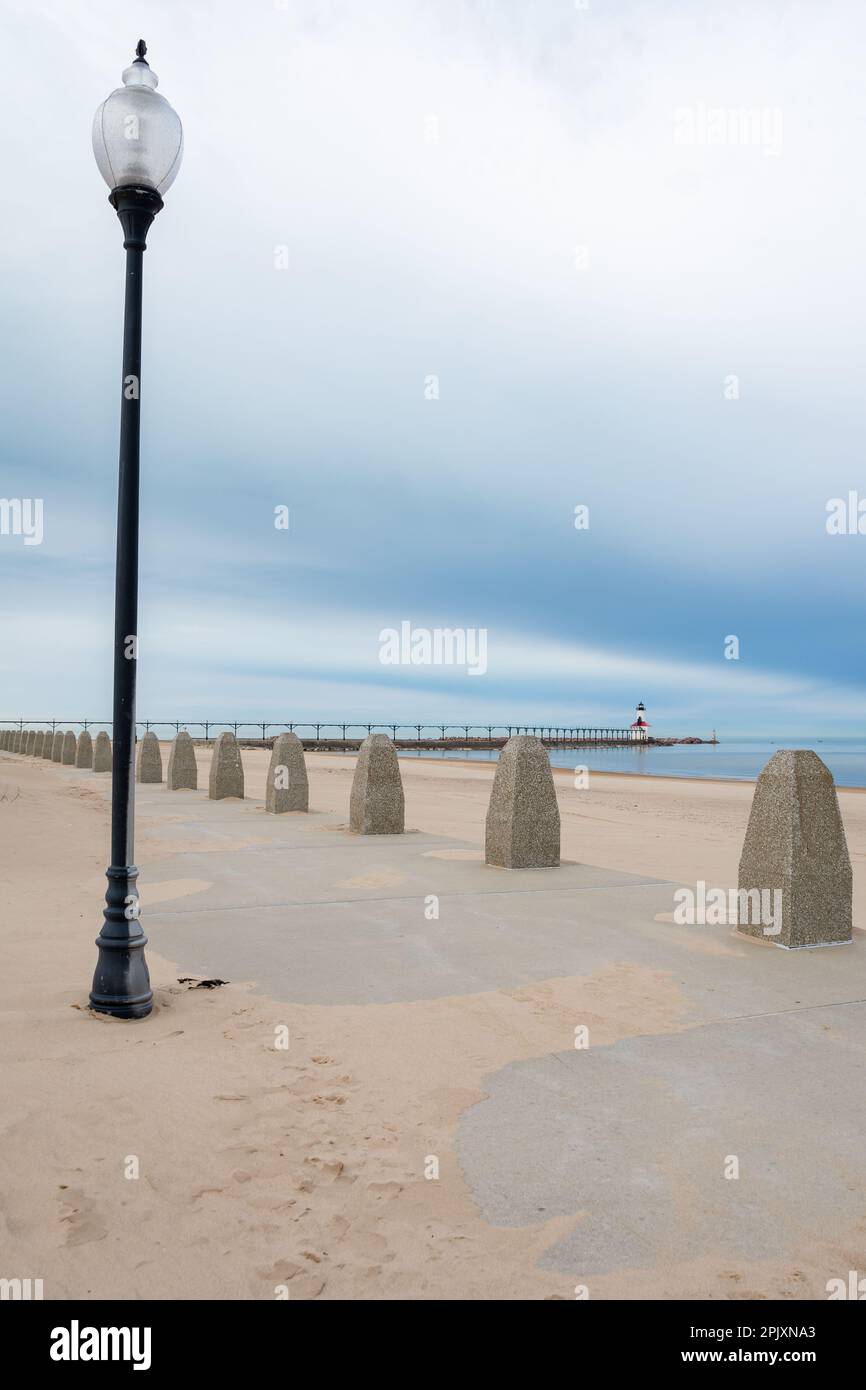 Michigan city beach and lighthouse as the early morning storms approach ...