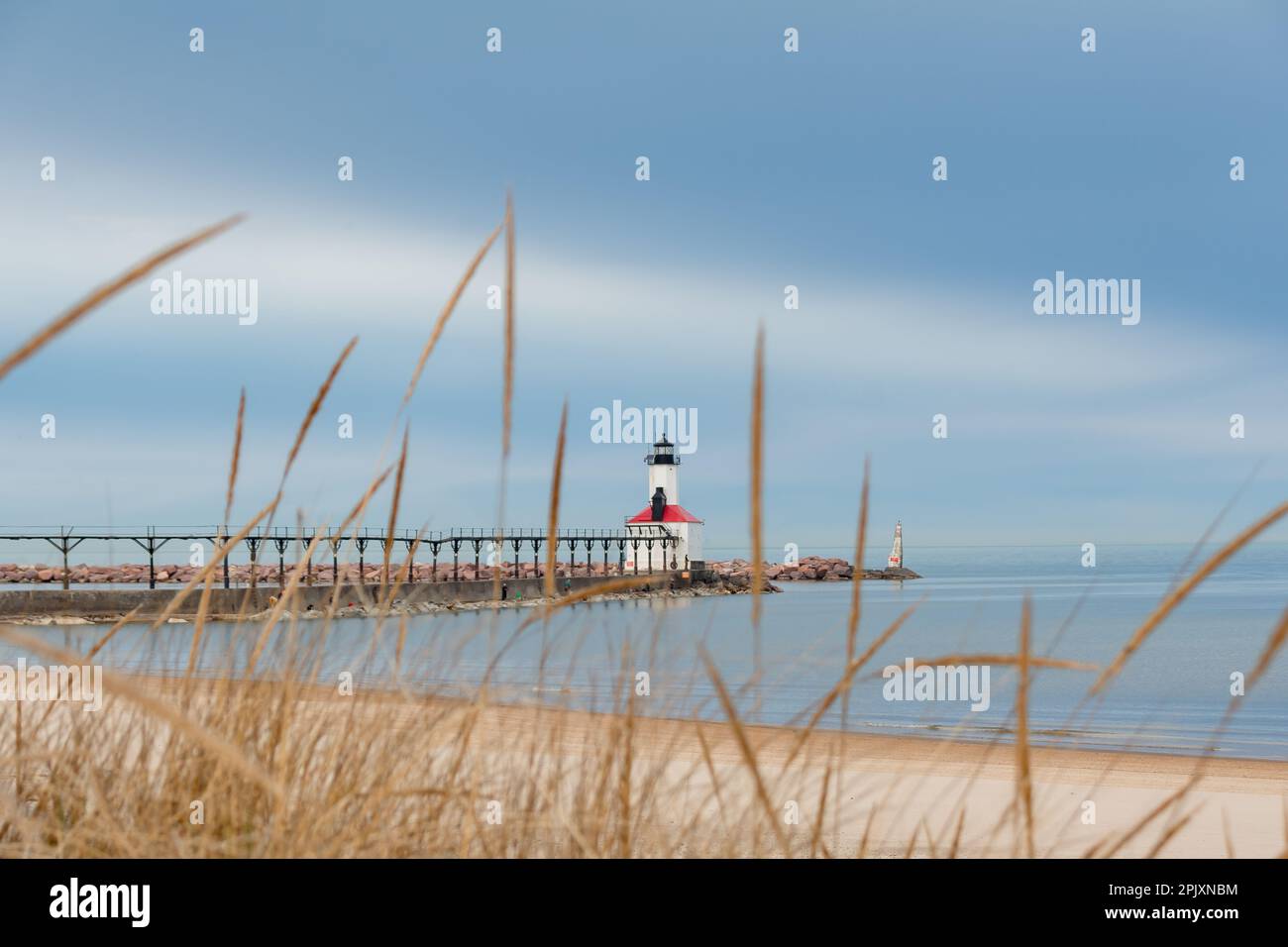 Michigan City Lighthouse and beach with storm clouds approaching ...