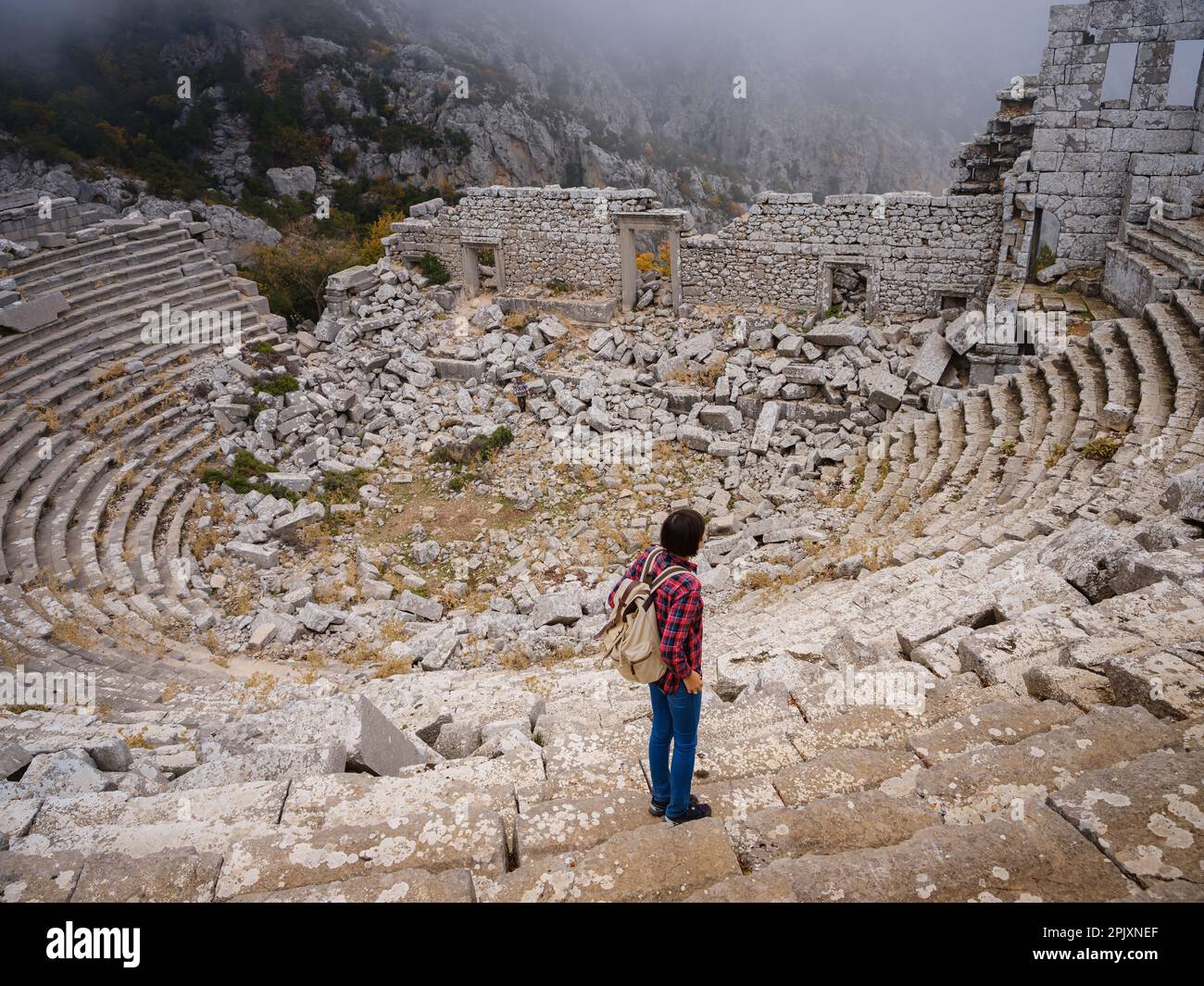 Autumn walk , woman looking at the ancient amphitheatre in city ...
