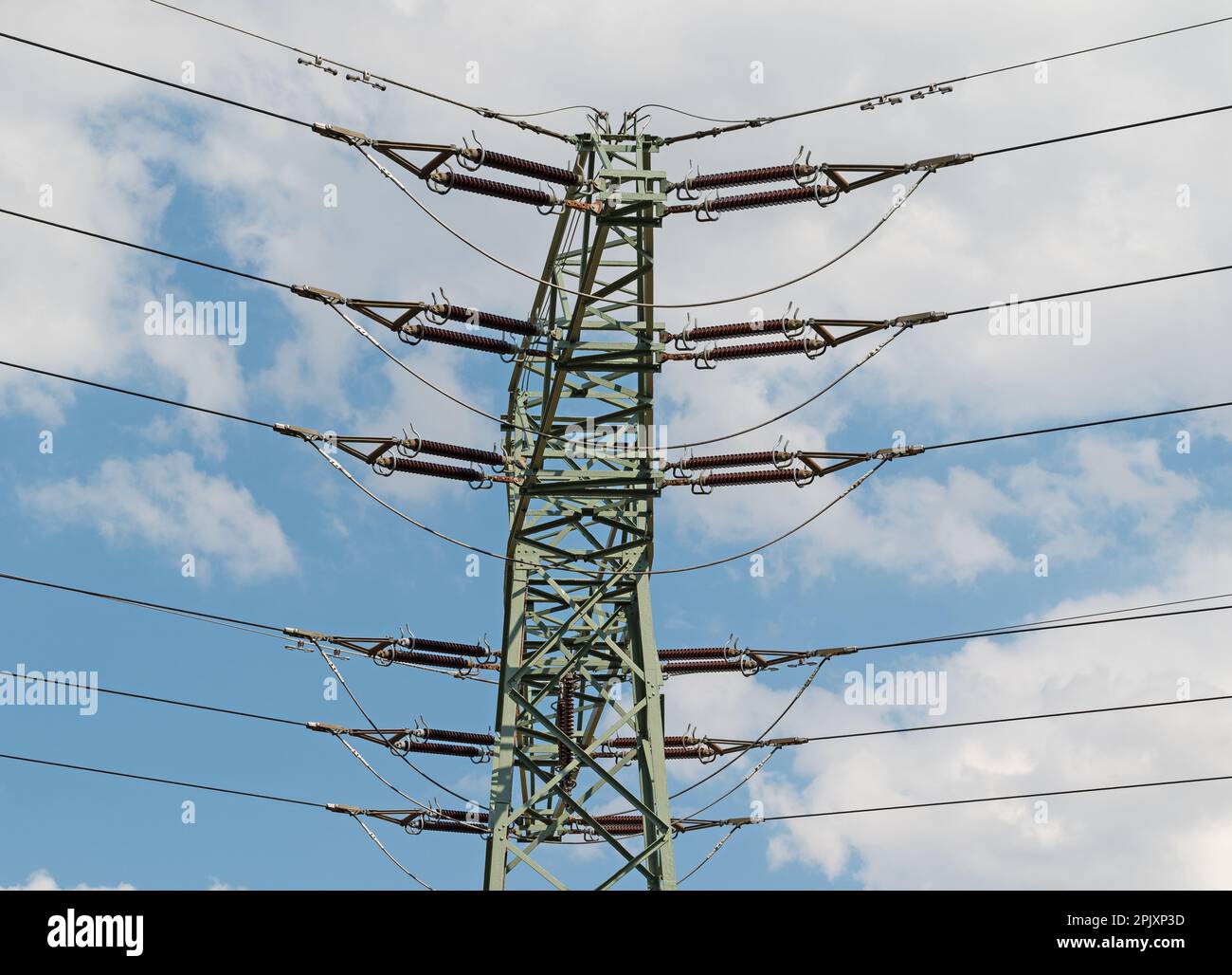 Power line pylon in front of sky with clouds Stock Photo - Alamy