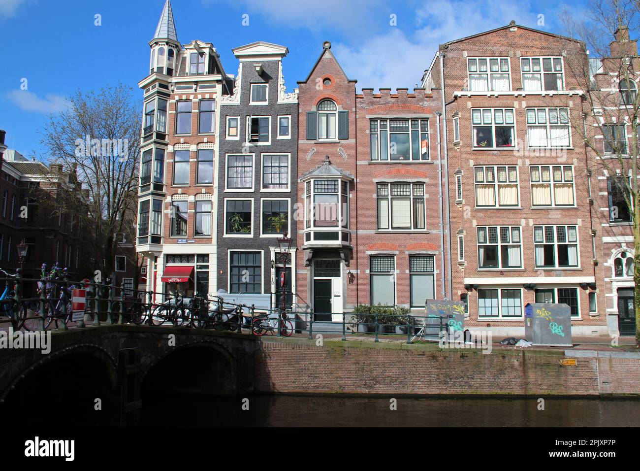 canal and old brick houses and flat buildings in amsterdam (the ...