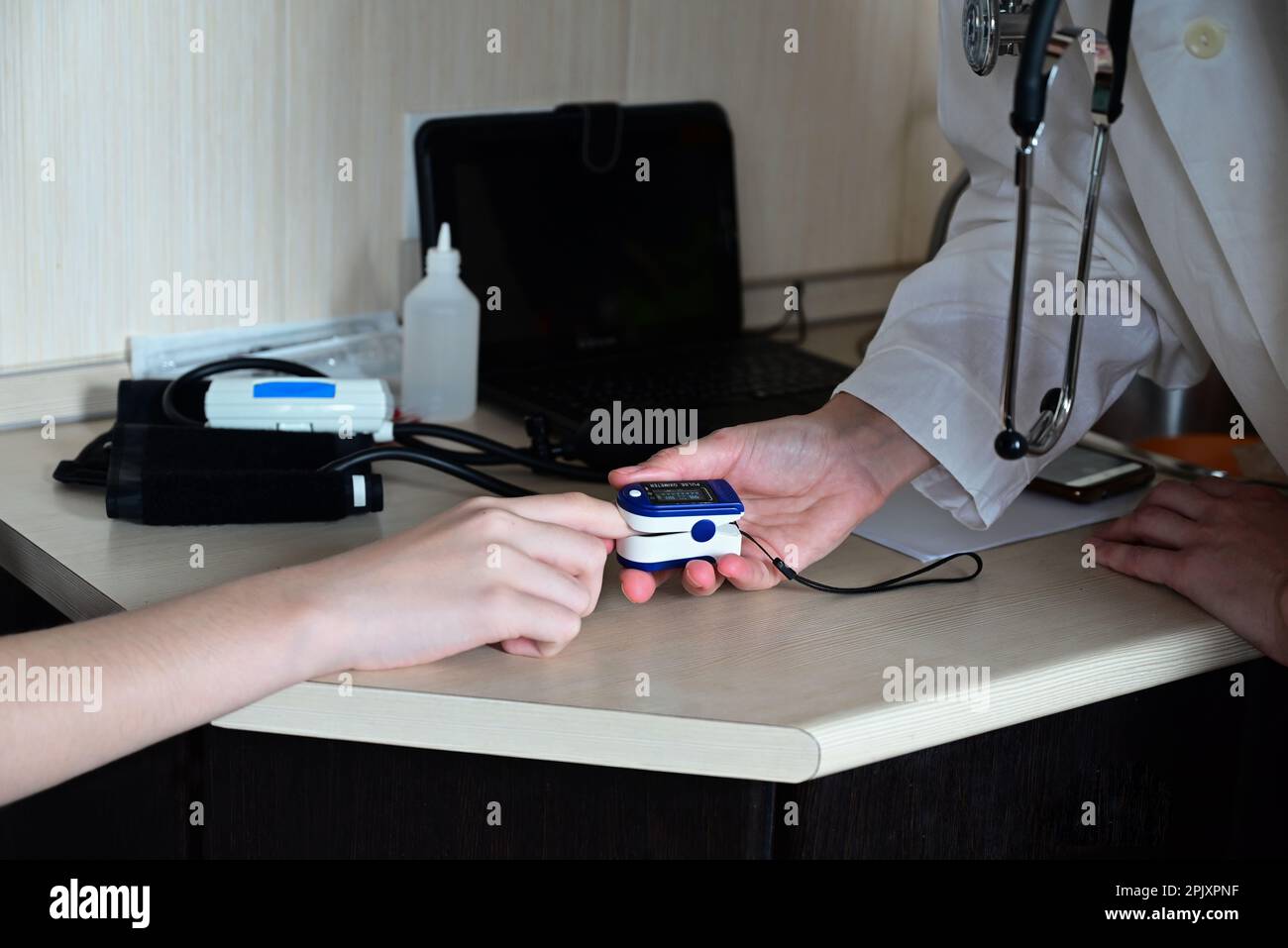 Oxygen test for the covid. Doctor examining patient with fingertip ...
