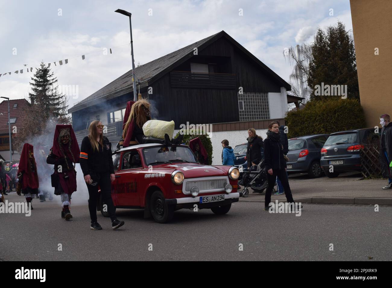 A group of people wearing costumes are walking during a traditional ...