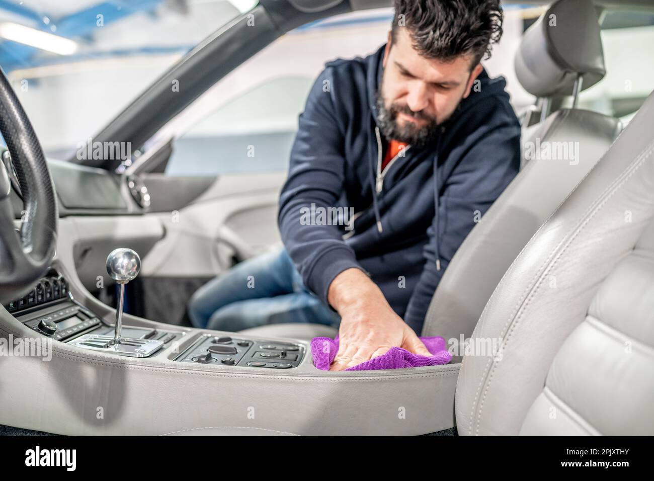 manual detailing and polishing of luxury car interiors with a ...