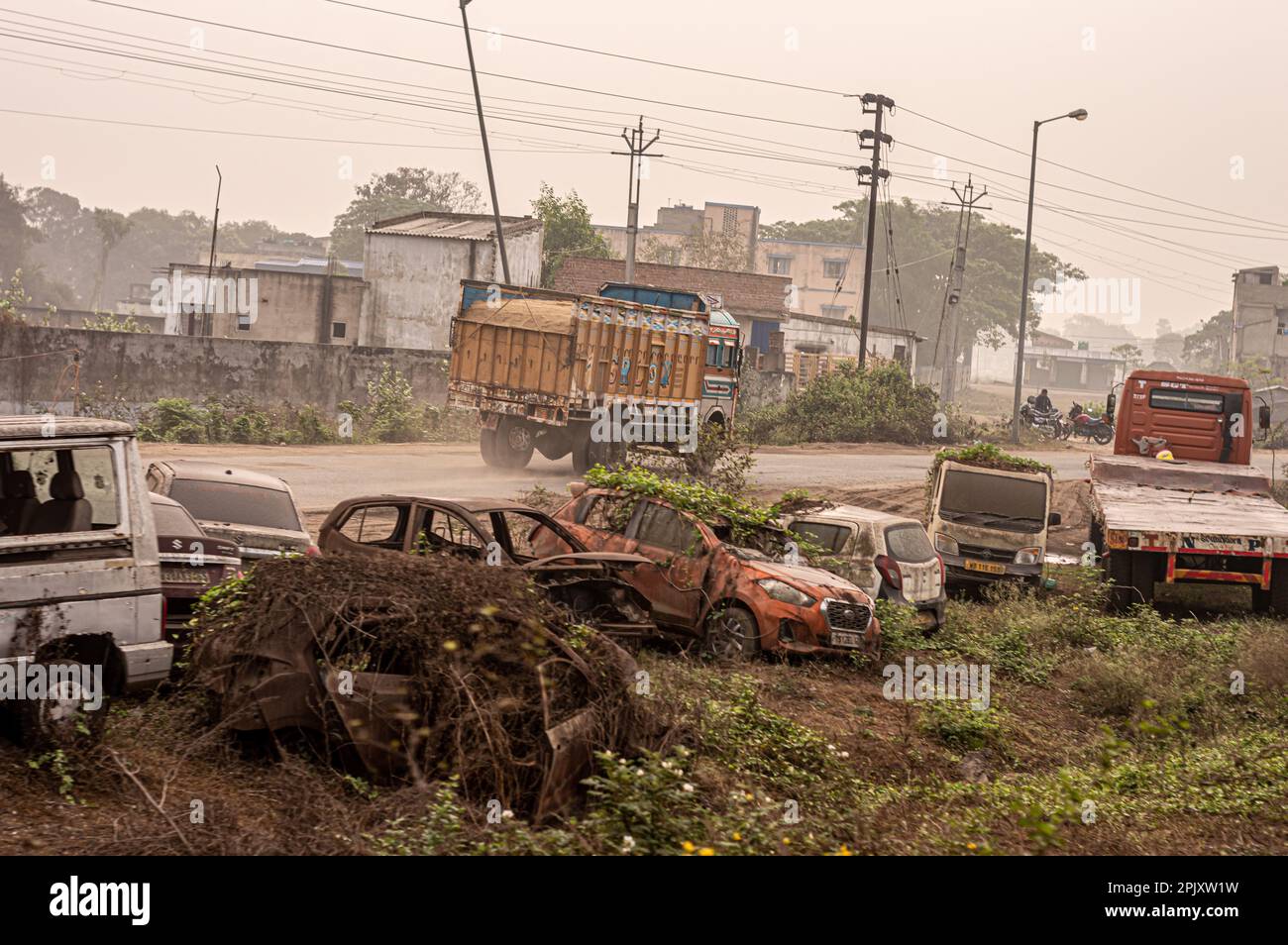 Broken and crashed cars dumped on a roadside. Scrap cars disposal ...