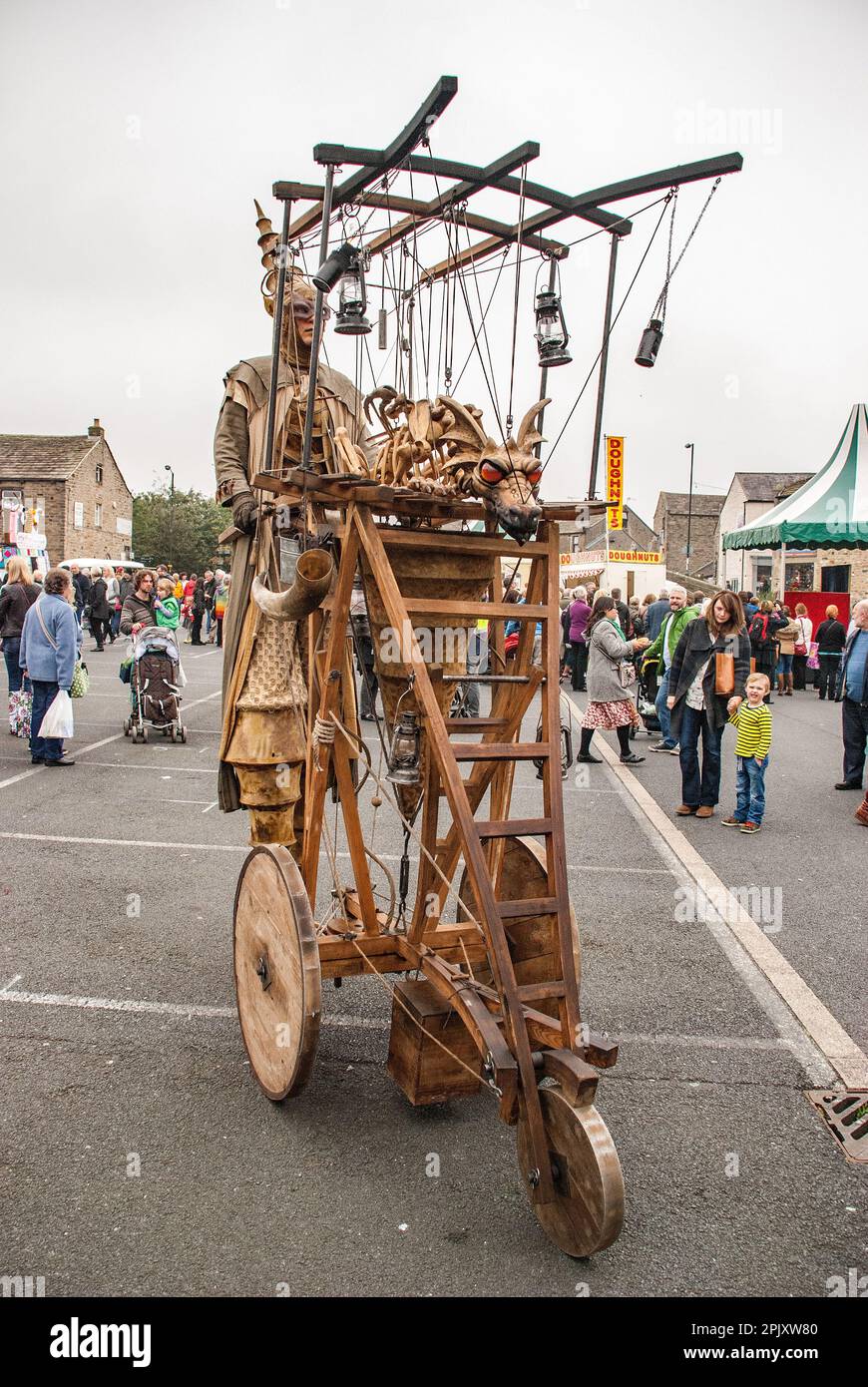 Person on stilts with a mobile contraption that sports a fire-breathing ...
