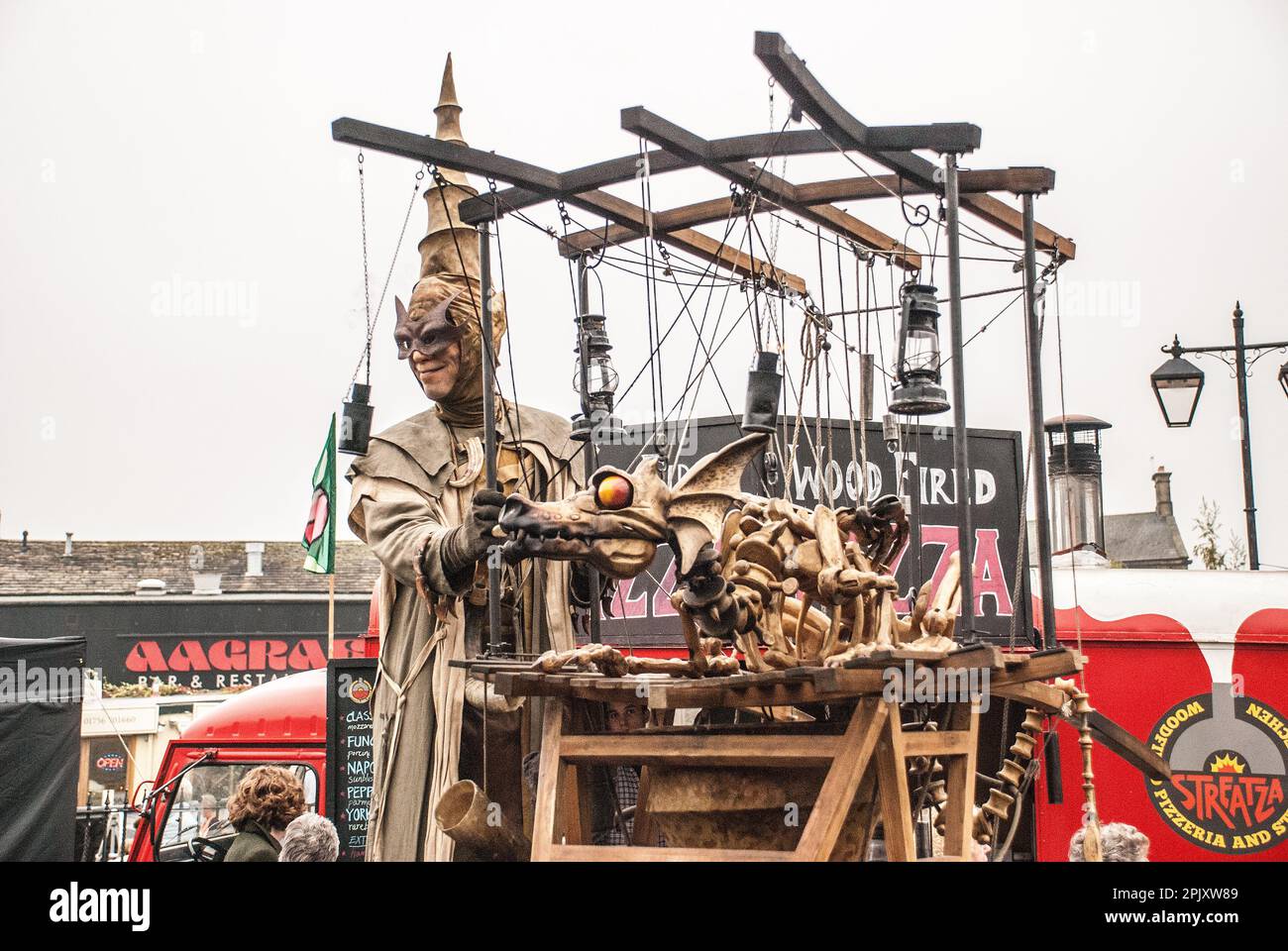 Person on stilts with a mobile contraption that sports a fire-breathing ...