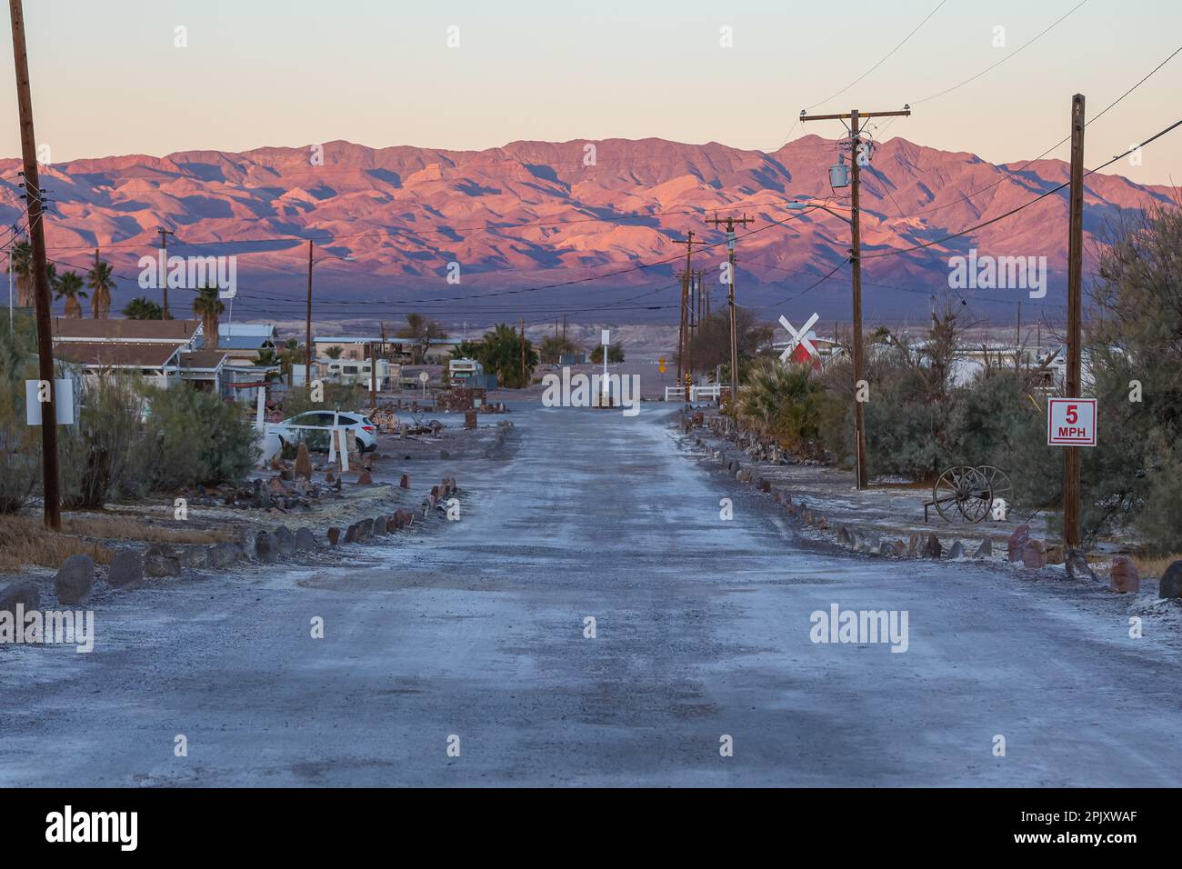 Sunrise illuminates the mountains to the west of the Mojave Desert town ...
