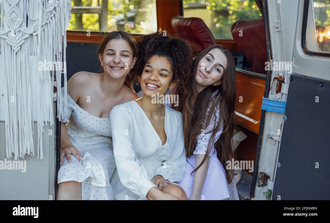 Pretty smiling three teenage girls in light dresses. Female teens of ...