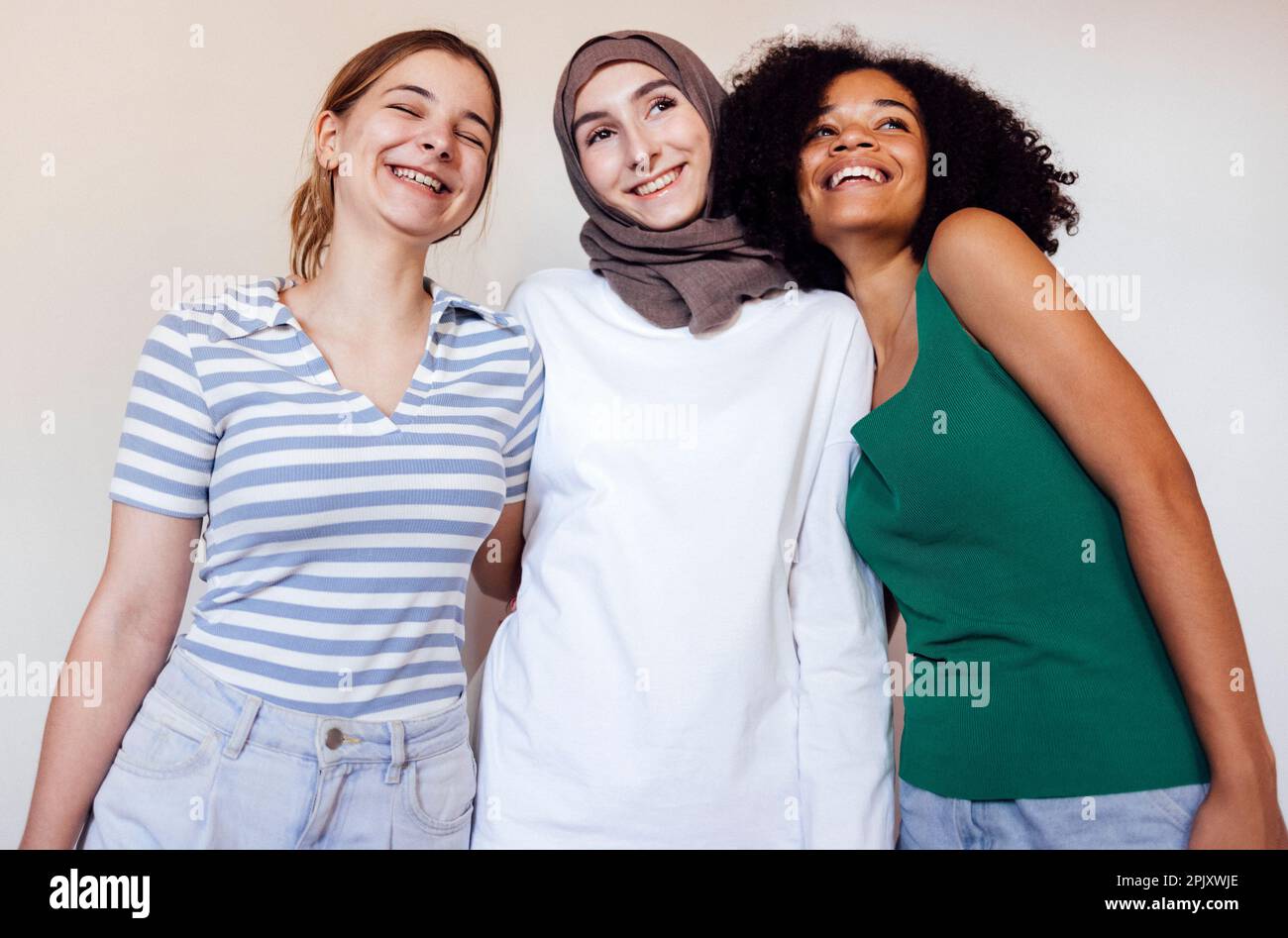 Close up portraits of three smiling teenage girls. Muslim in a hijab ...