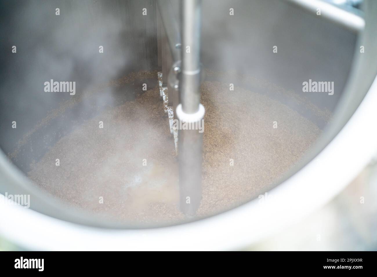 stainless steel boiler for brewing beer in a brewery. malt in the tank ...