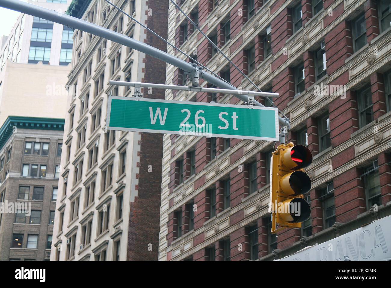 Green big West 26th Street sign hanging on a arch pole in the streets ...