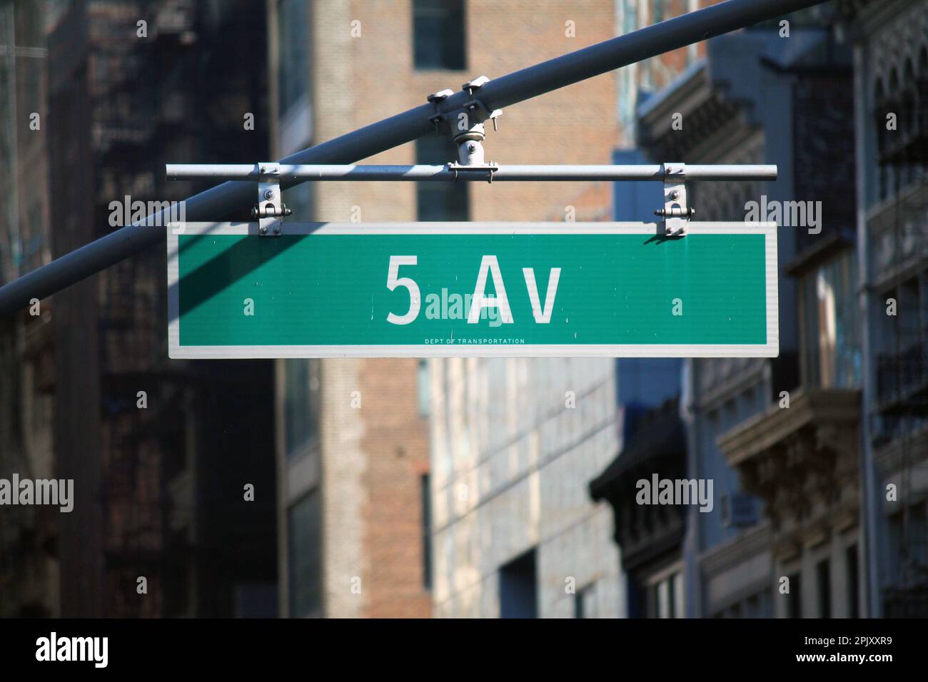 Green big 5th Avenue sign hanging on a arch pole in the streets of ...